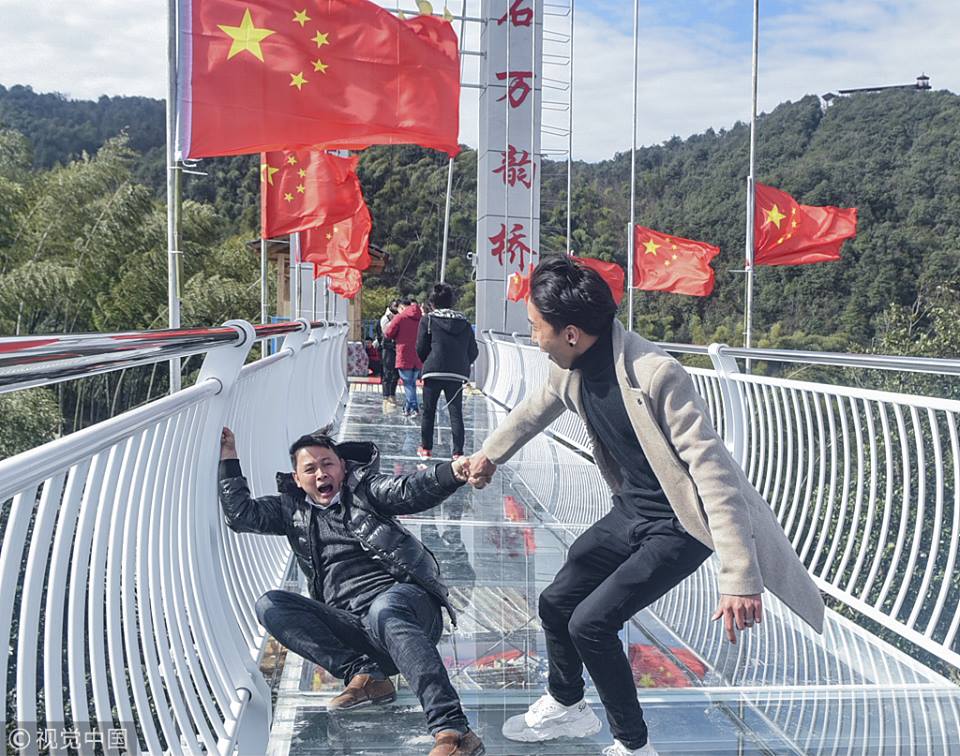 See How Scared Tourists Walked On Glass-bottomed Bridge in China. Photos